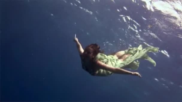 Underwater model free diver in red dress on background of corals in Red ...