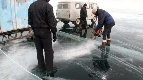 People cut ice for ice holes on Baikal. — Stock Video © VIDEOTON #325255198