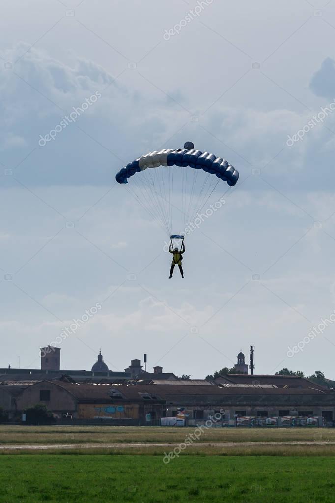 Parachutist with Blue Parachute near to the Ground Preparing for ...