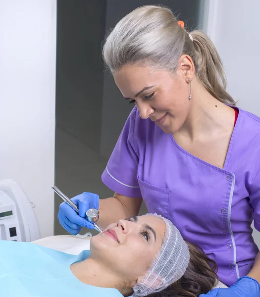 Young beautiful woman gets professional skin treatment - Stock Image ...