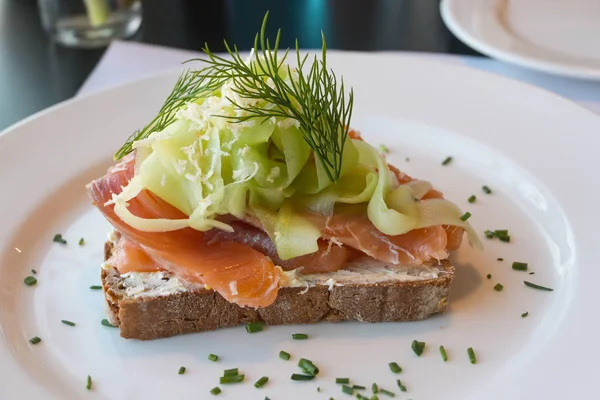 whole grain bread with salmon, cucumber, horseradish flakes and dill ...