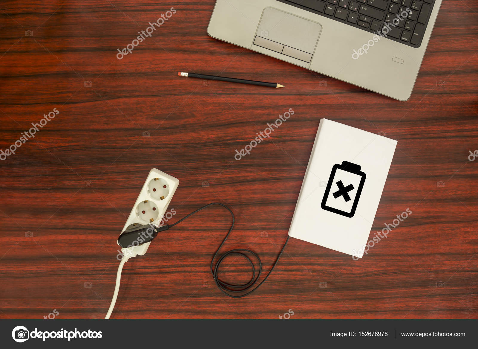 Book charging on a desk Stock Photo by ©nikolay100 152678978
