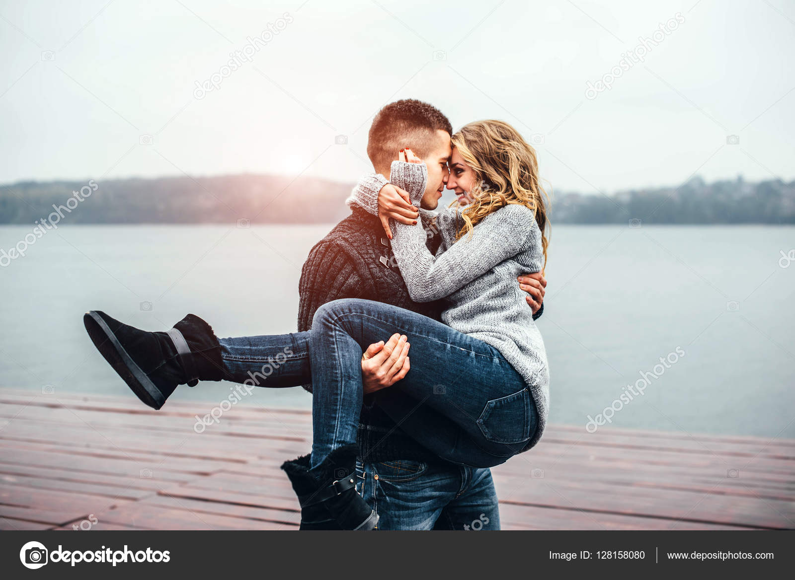 Guy Holding Girl In Arms Kissing