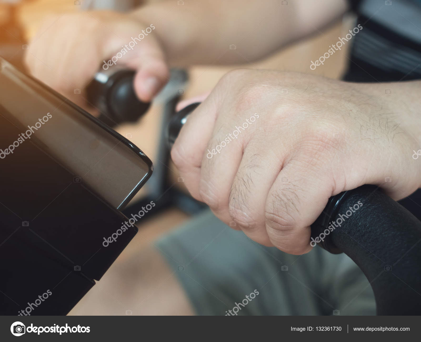 Close up fat man hands on exercise bike. Stock Photo by ©eggeeggjiew ...