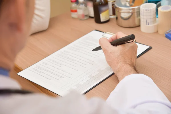 Doctor writing on a medical chart ⬇ Stock Photo, Image by © XiXinXing ...