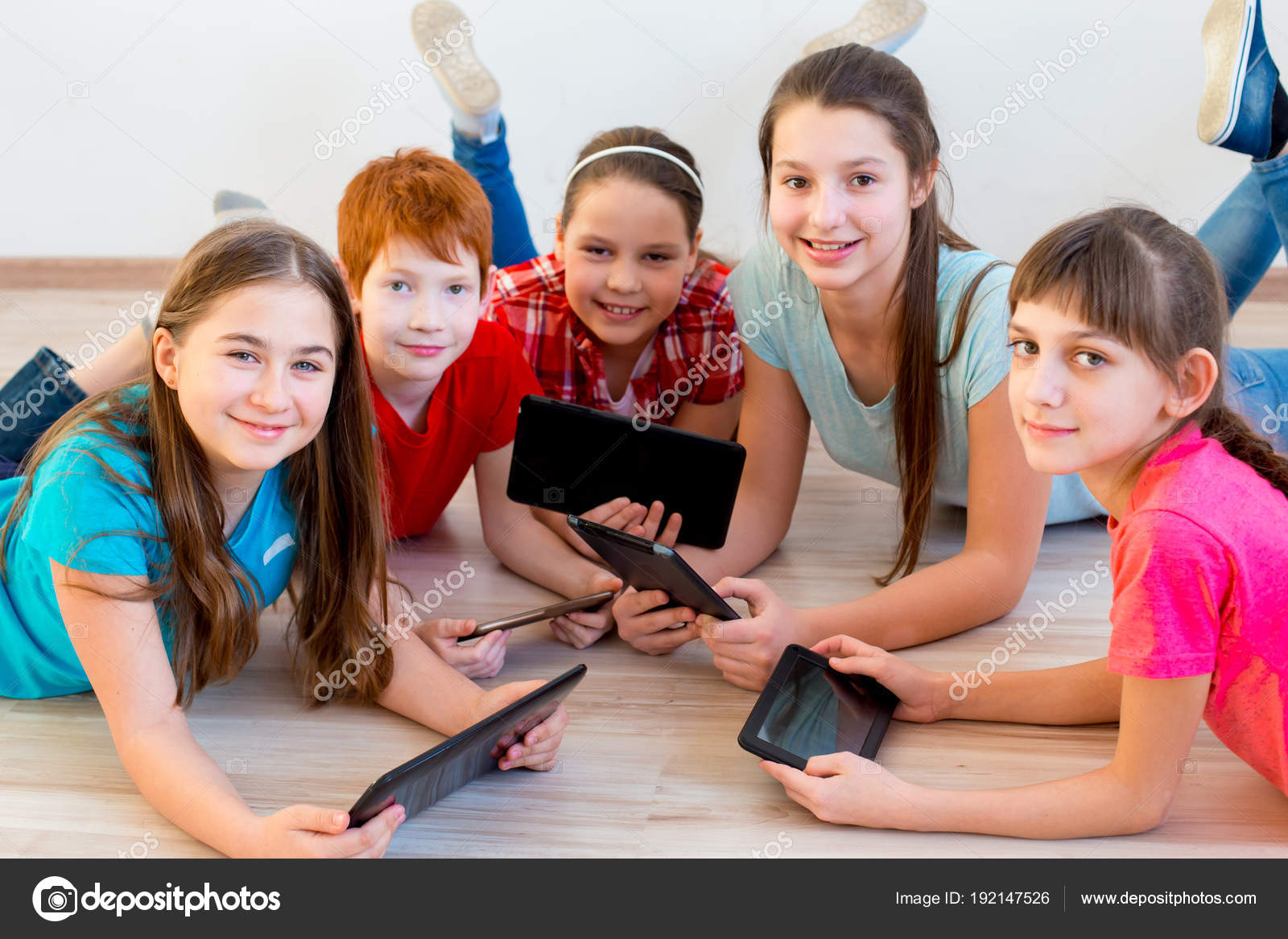 Kids using different gadgets Stock Photo by ©Lenanichizhenova 192147526