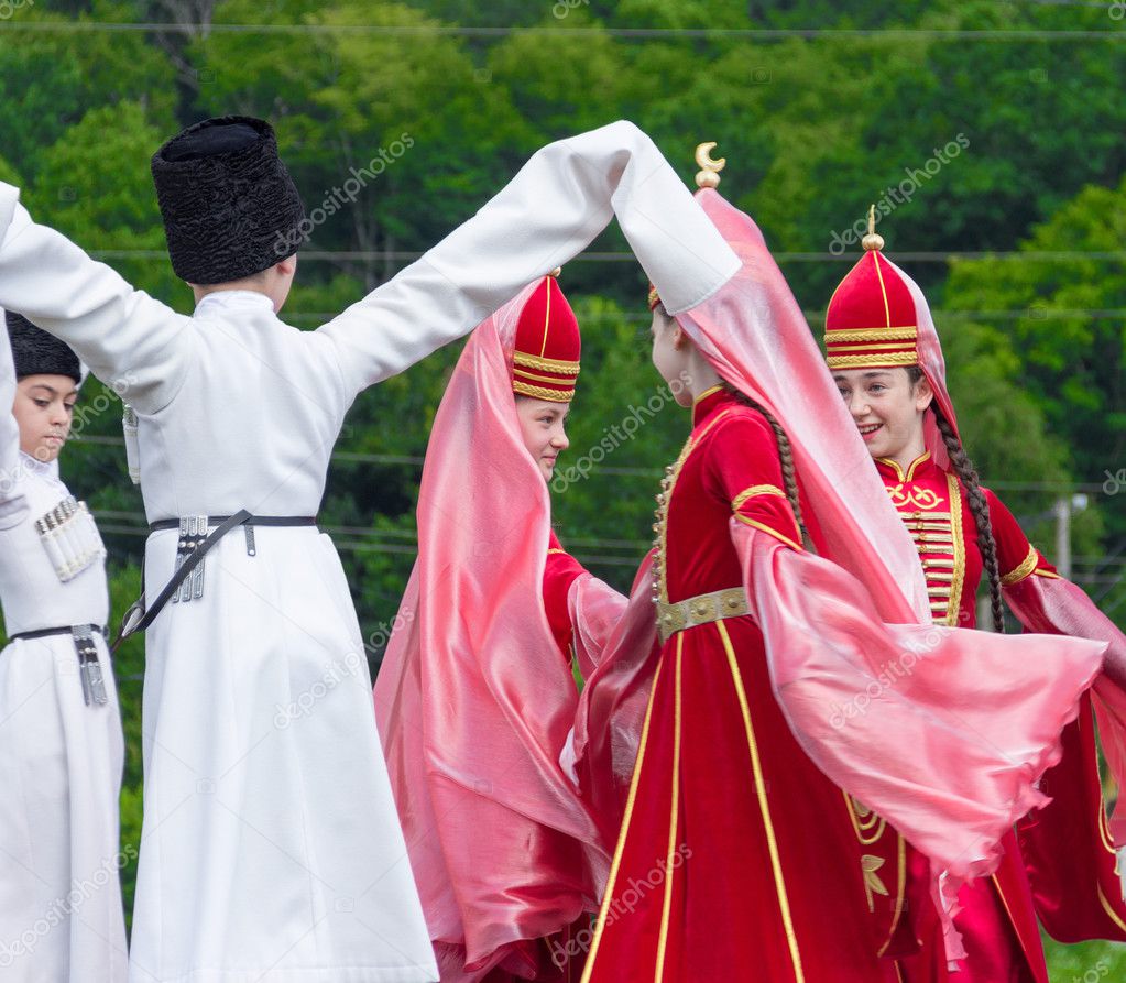 Adyghe girls and boys in national costumes dance to the Circassian ...