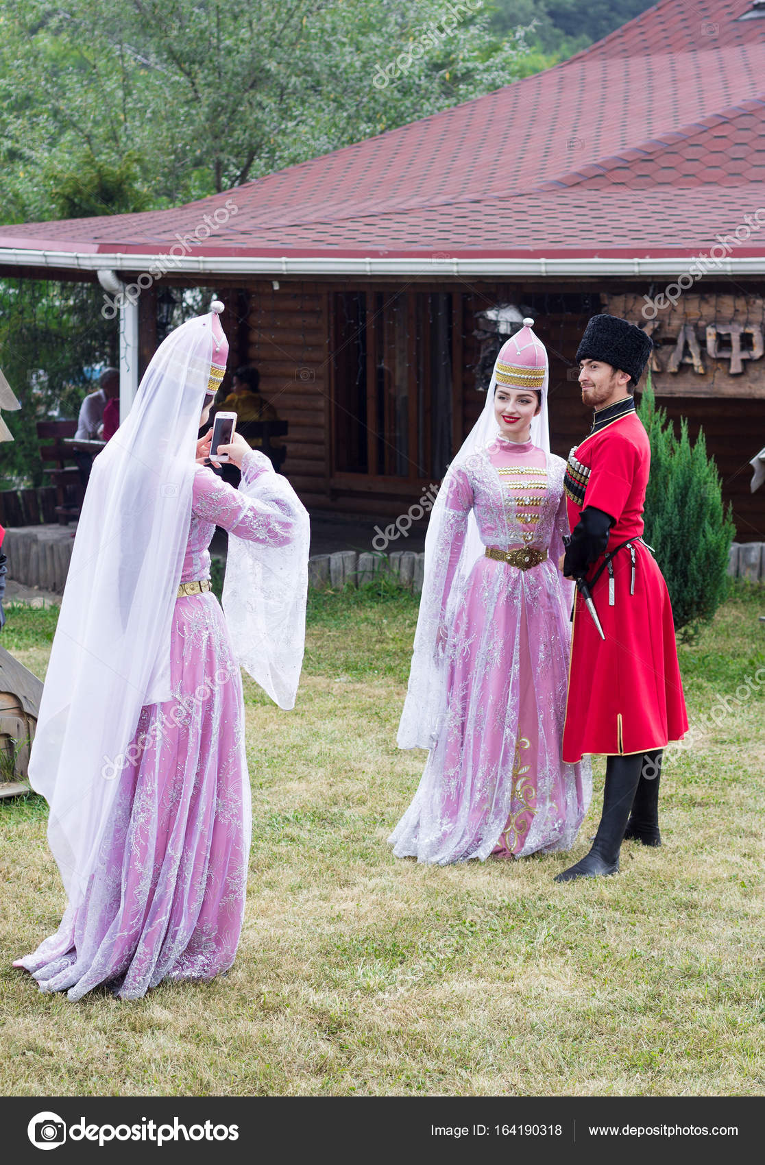 Beautiful young girls and a boy are photographed on a mobile phone in ...