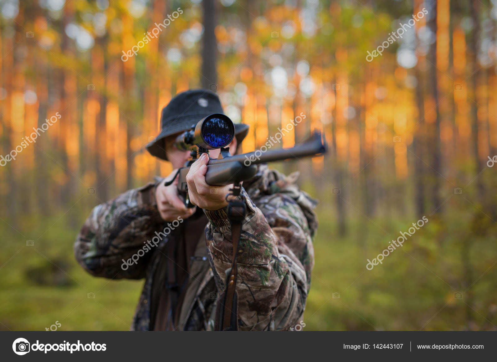 Hunter looking into the rifle — Stock Photo © grinvalds #142443107