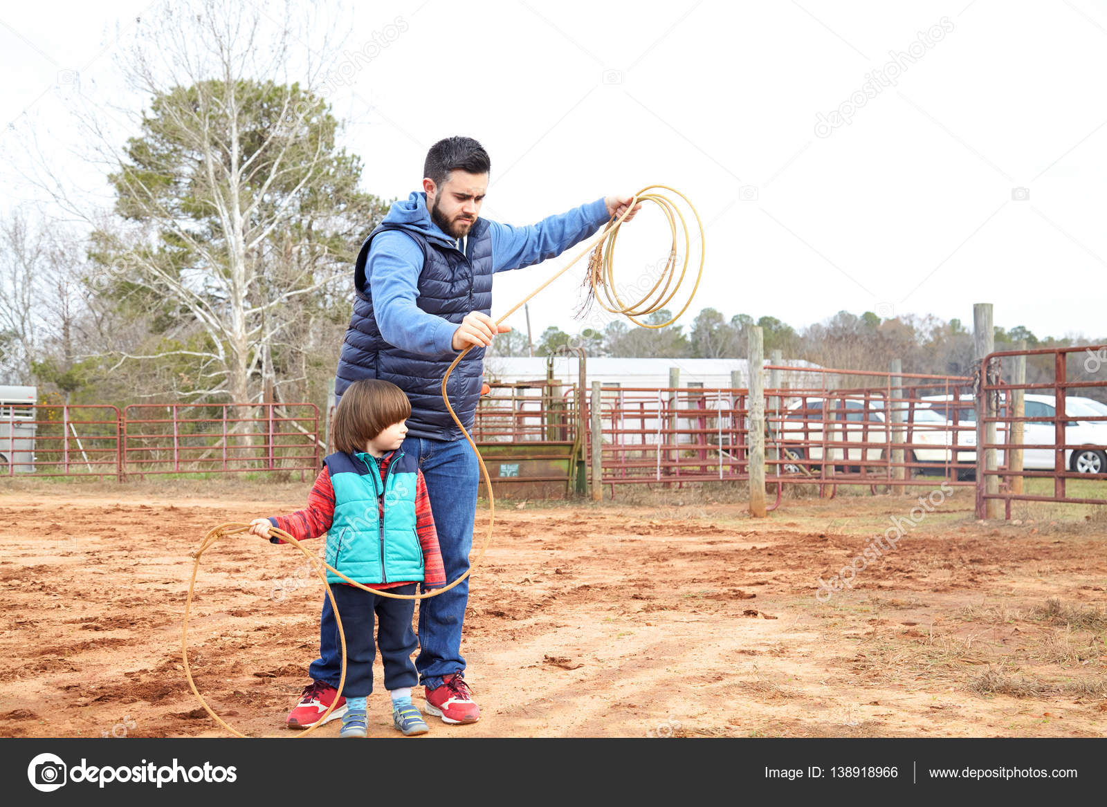 Father learning son making loop and throwing lasso in ranch — Stock ...