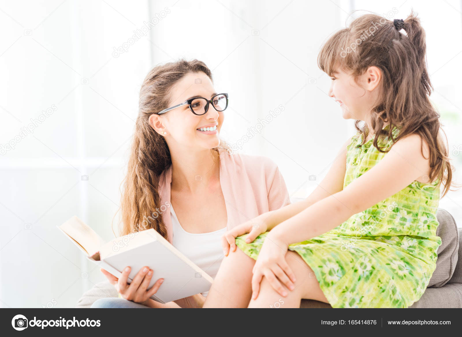 Mother and daughter reading together Stock Photo by ©stockasso 165414876