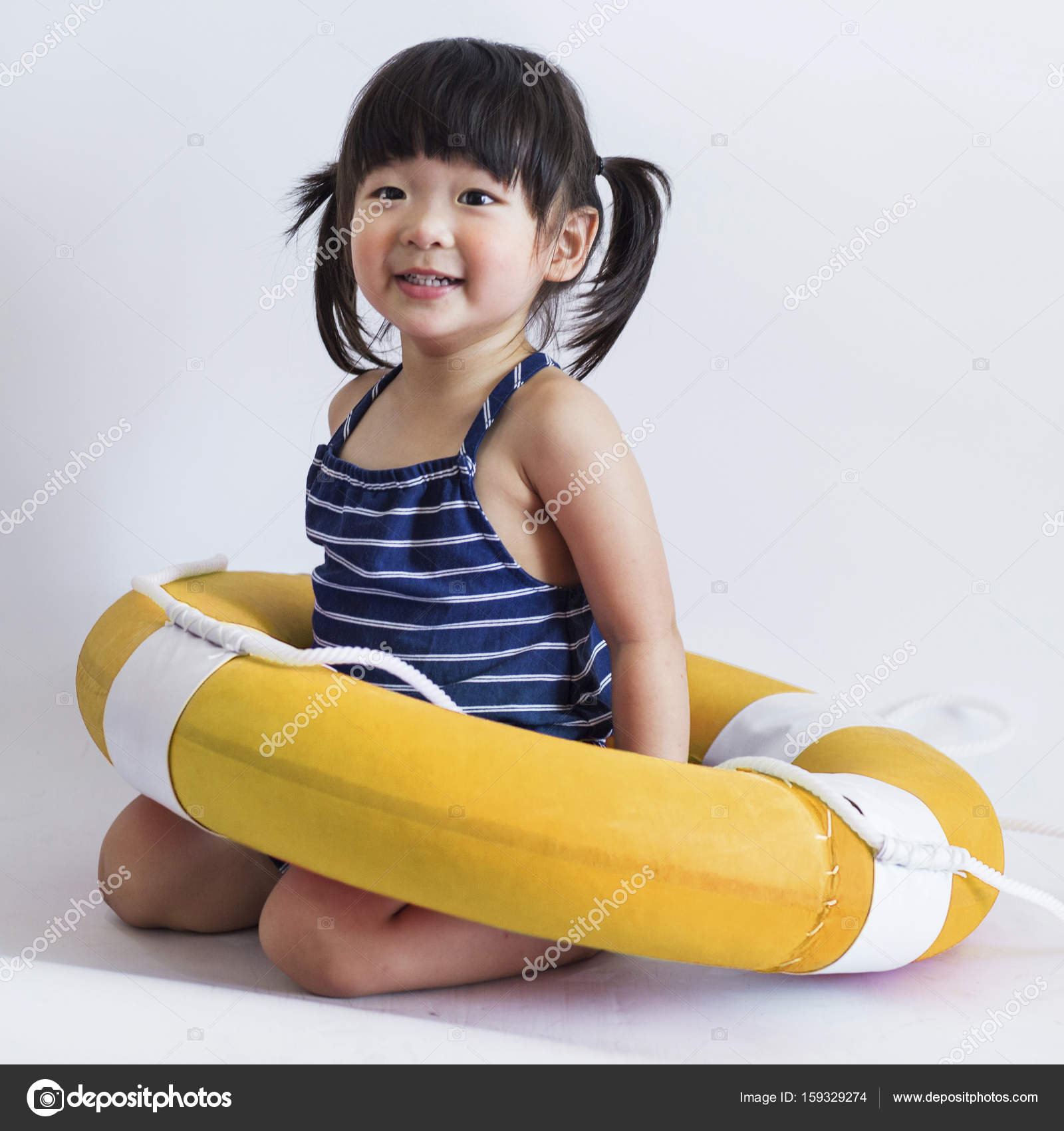 Cute and innocent japanese kid with life ring on white backgroun Stock ...