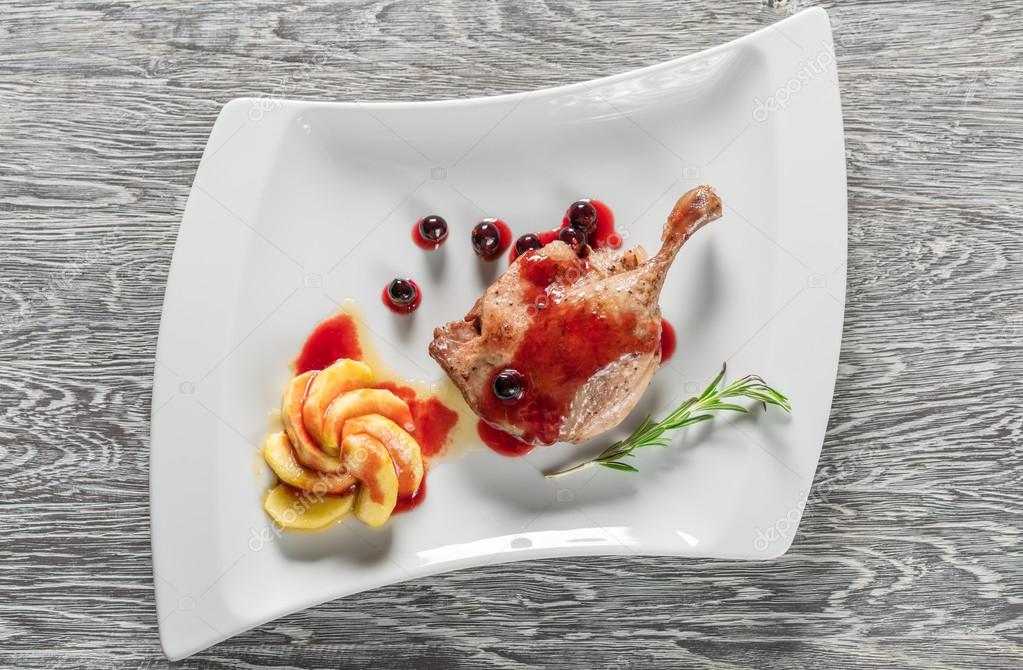 A healthy Breakfast of duck legs confit with caramelized Apple served ...