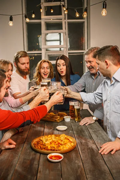 Group of friends enjoying evening drinks with beer - Stock Image ...