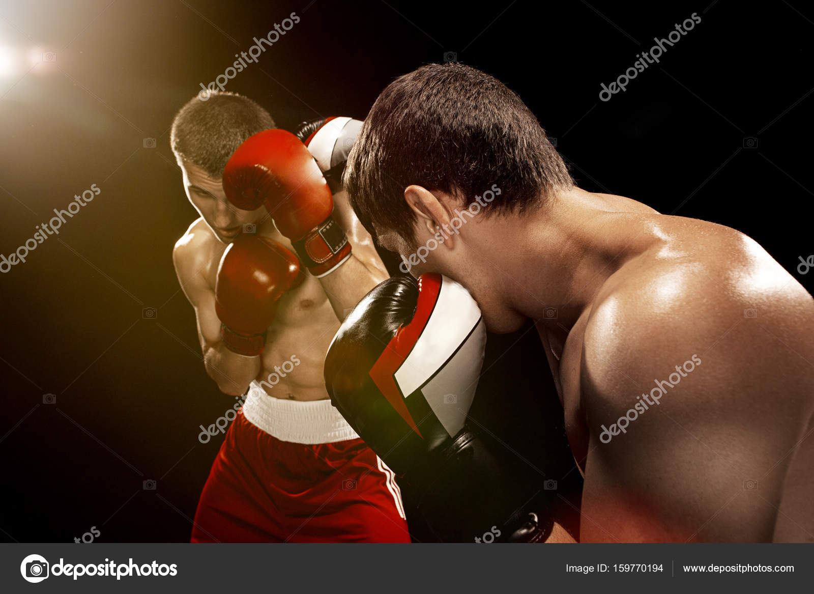 Two professional boxer boxing on black background, Stock Photo by ...