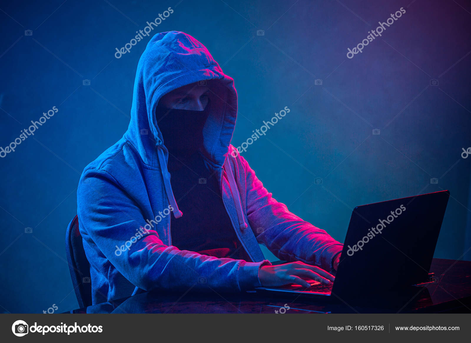 Hooded computer hacker stealing information with laptop — Stock Photo © vova130555@gmail.com ...
