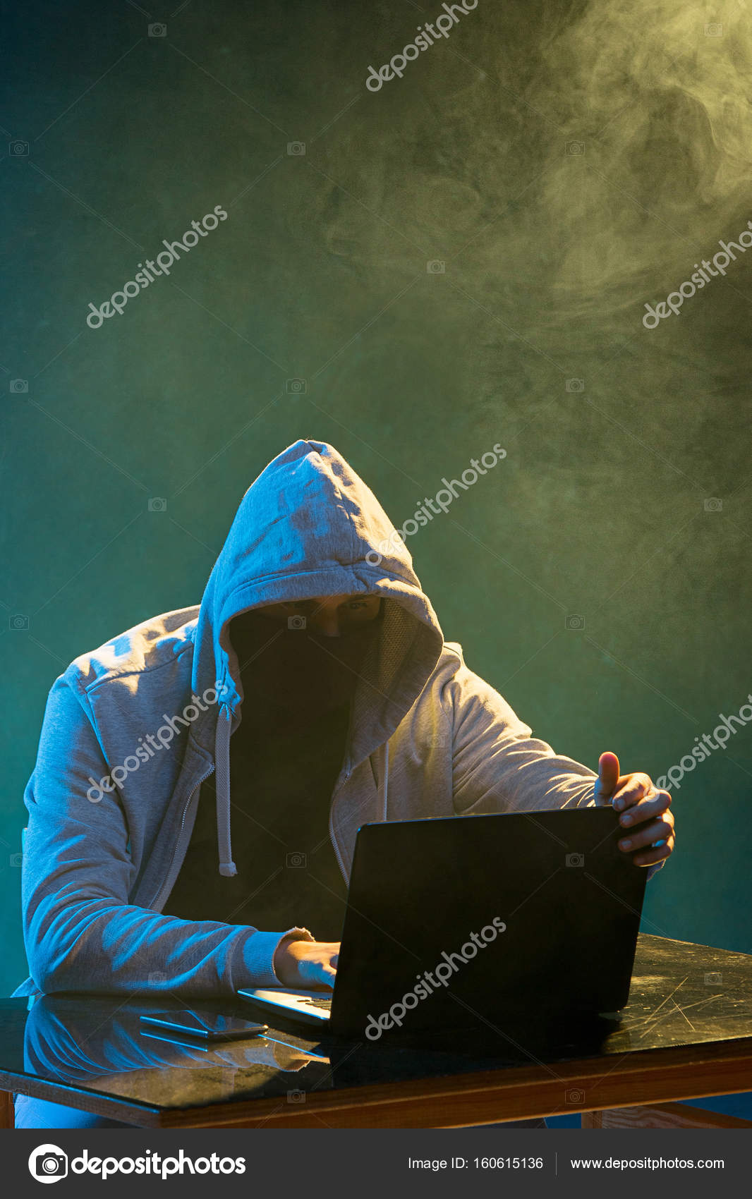 Hooded computer hacker stealing information with laptop Stock Photo by ...