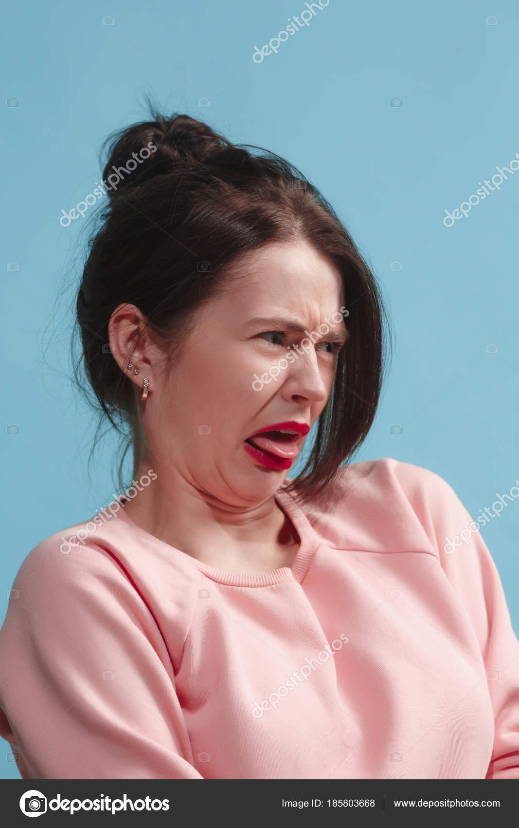 Young woman with disgusted expression repulsing something, isolated on ...