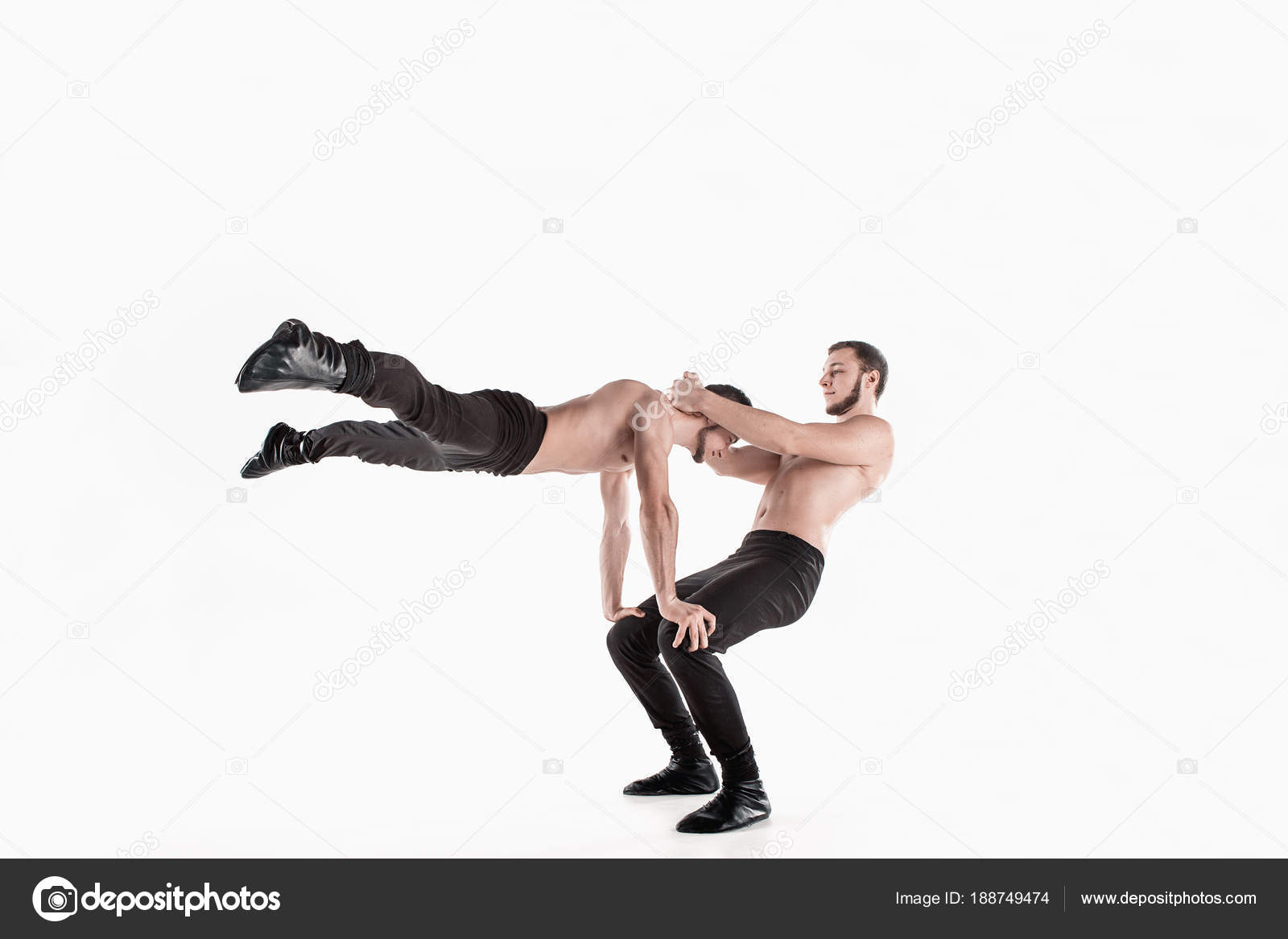 The group of gymnastic acrobatic caucasian men on balance pose Stock ...