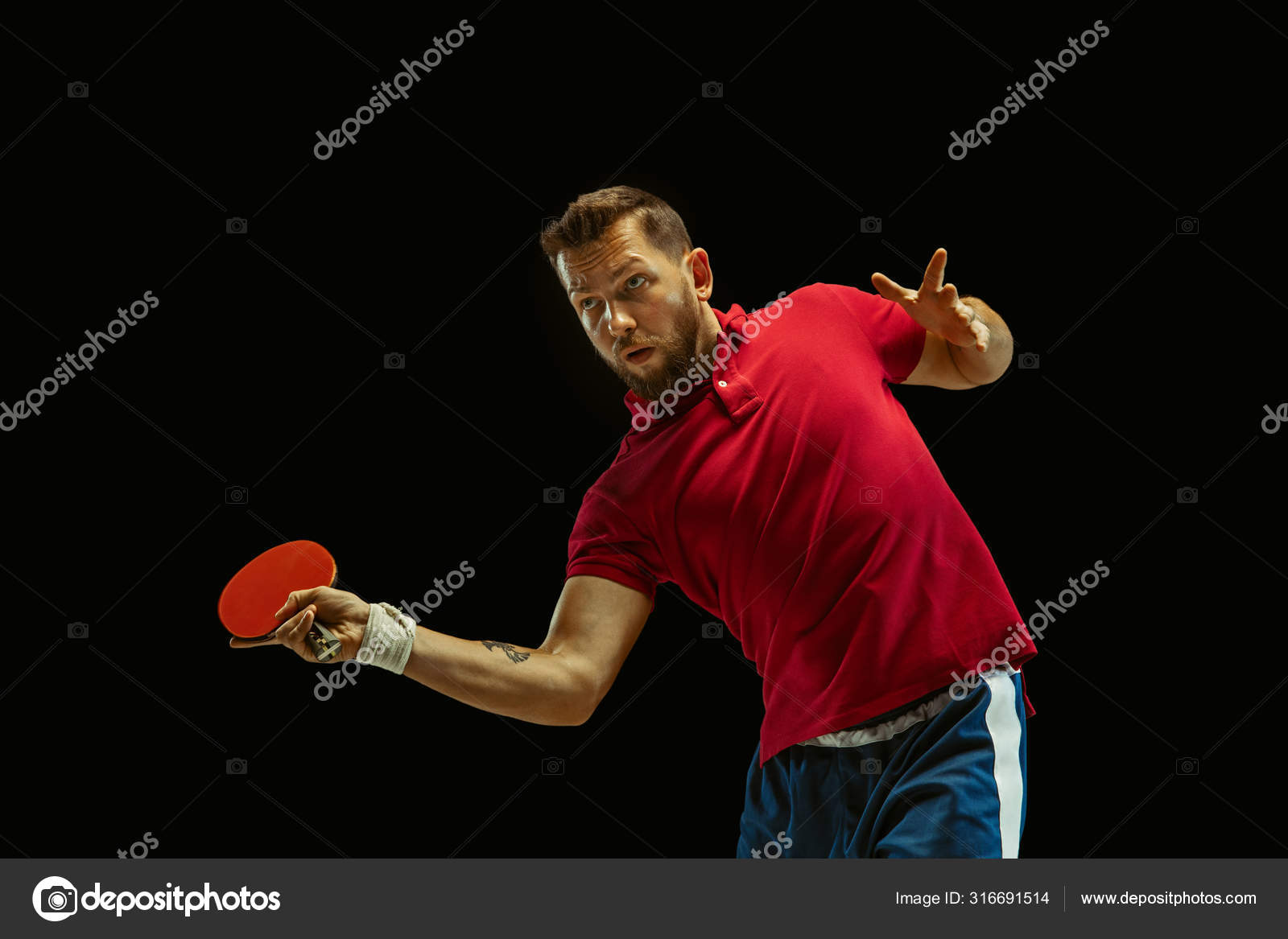Young man playing table tennis on black studio background Stock Photo ...