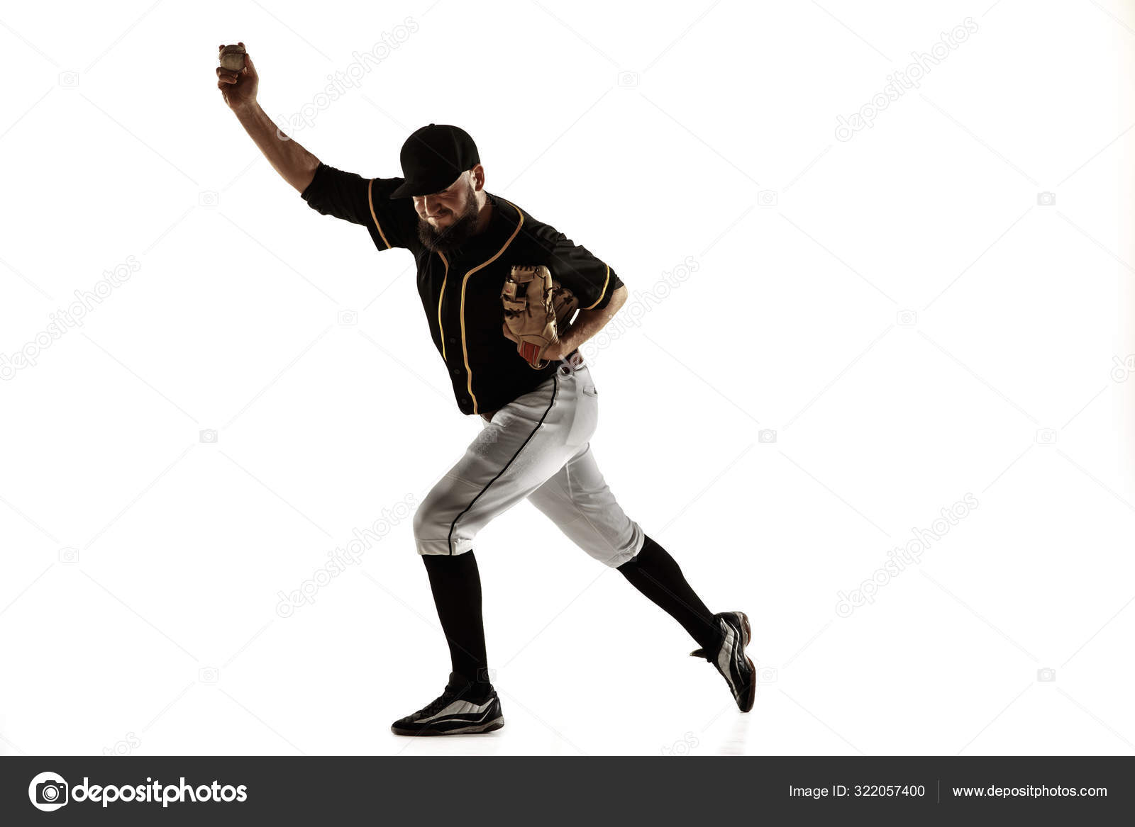Baseball player, pitcher in a black uniform practicing on a white ...
