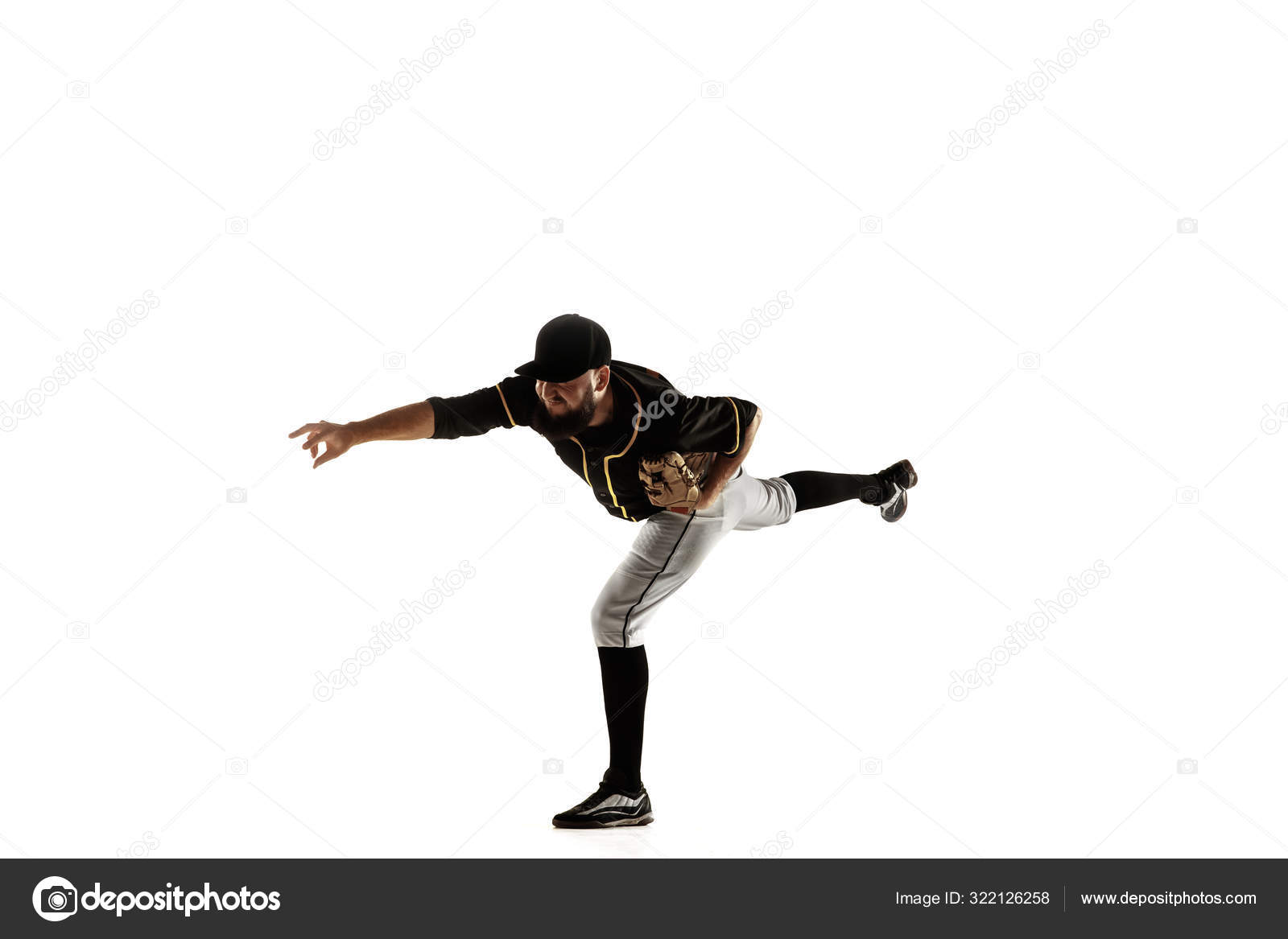Baseball player, pitcher in a black uniform practicing on a white ...