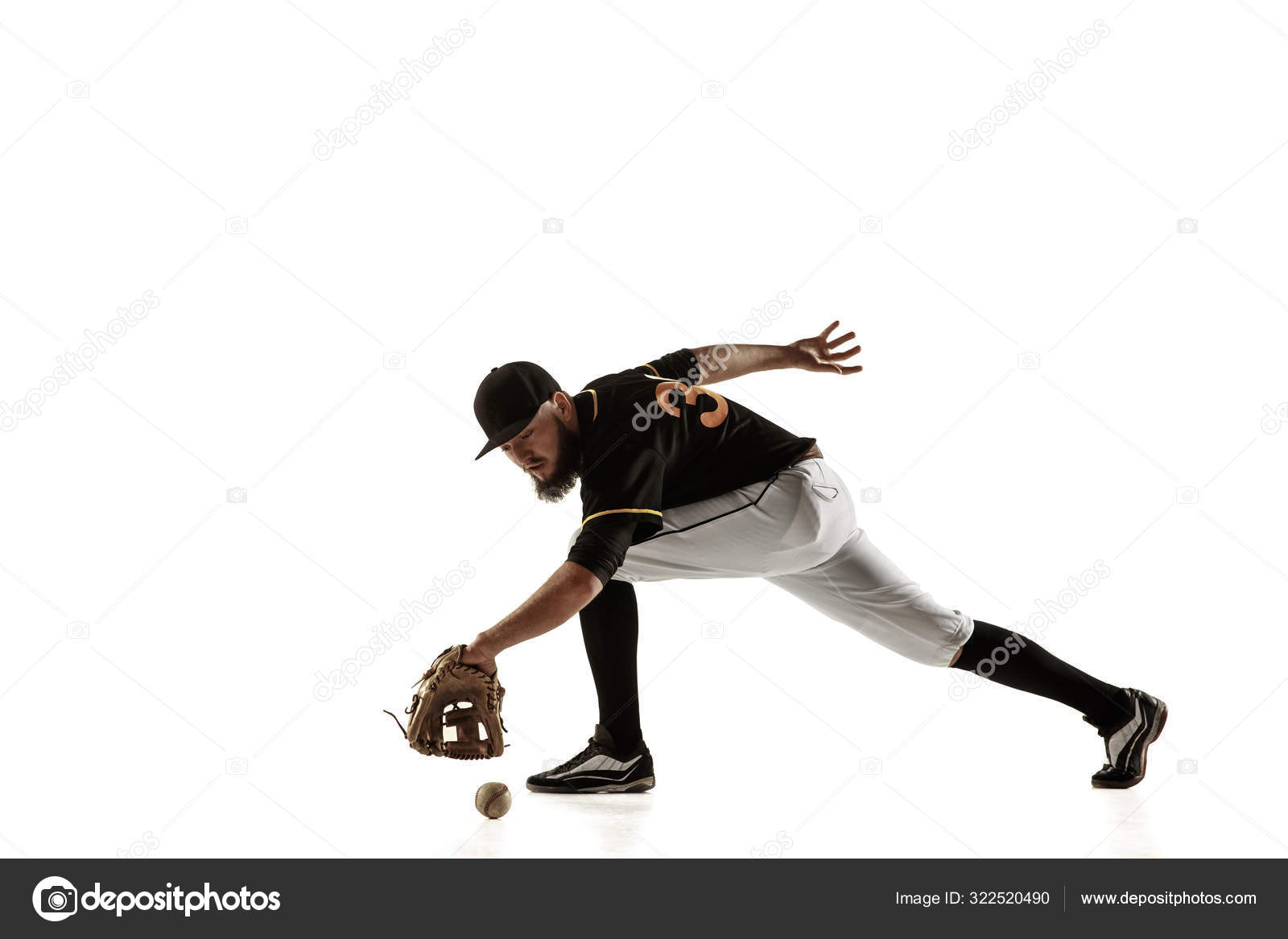 Baseball player, pitcher in a black uniform practicing on a white ...