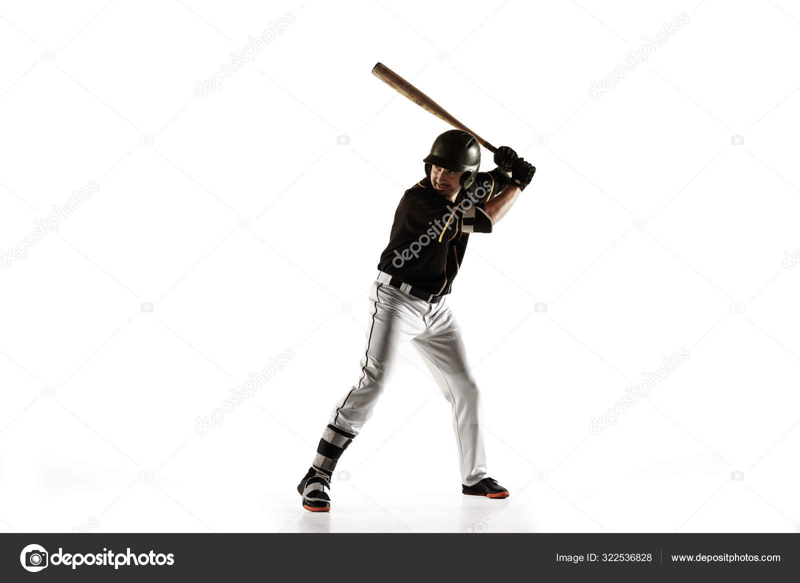 Baseball player, pitcher in a black uniform practicing on a white ...