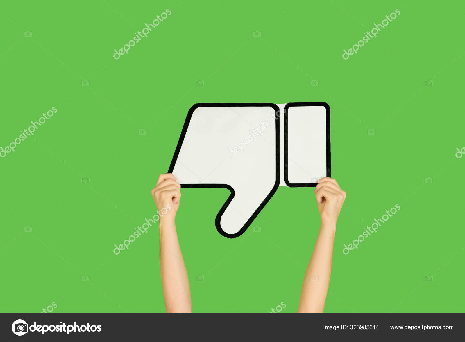 Hands holding the sign of dislike on green studio background Stock ...