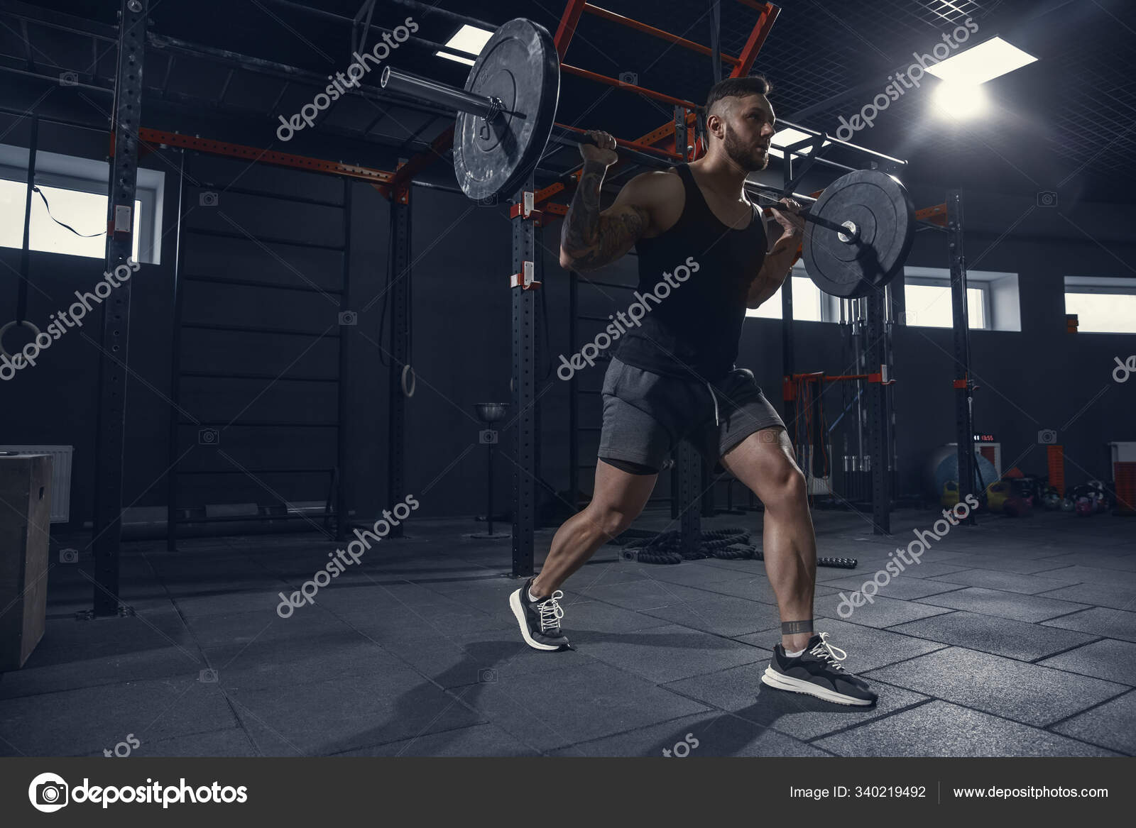 The male athlete training hard in the gym. Fitness and healthy life ...