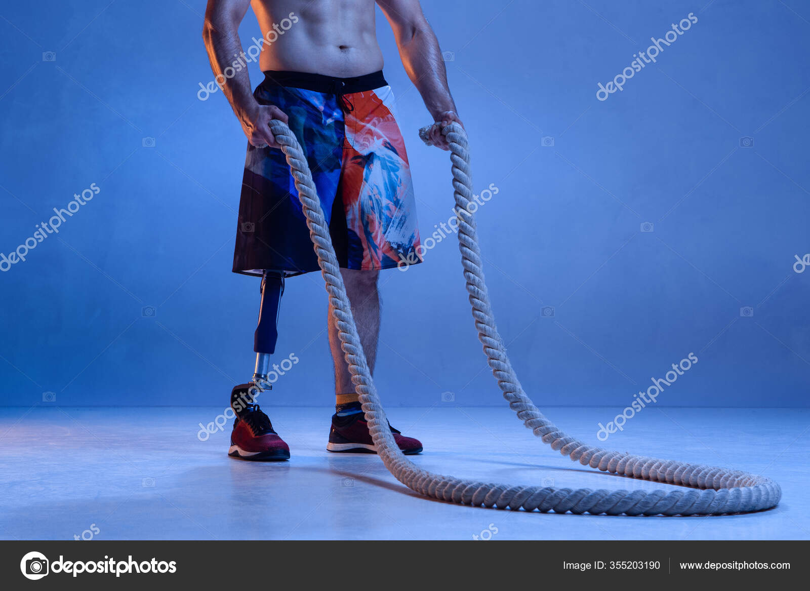 Athlete disabled amputee isolated on blue studio background Stock Photo ...