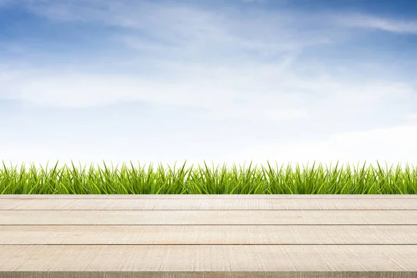 Wood table top panel and grass on green background — Stock Photo ...