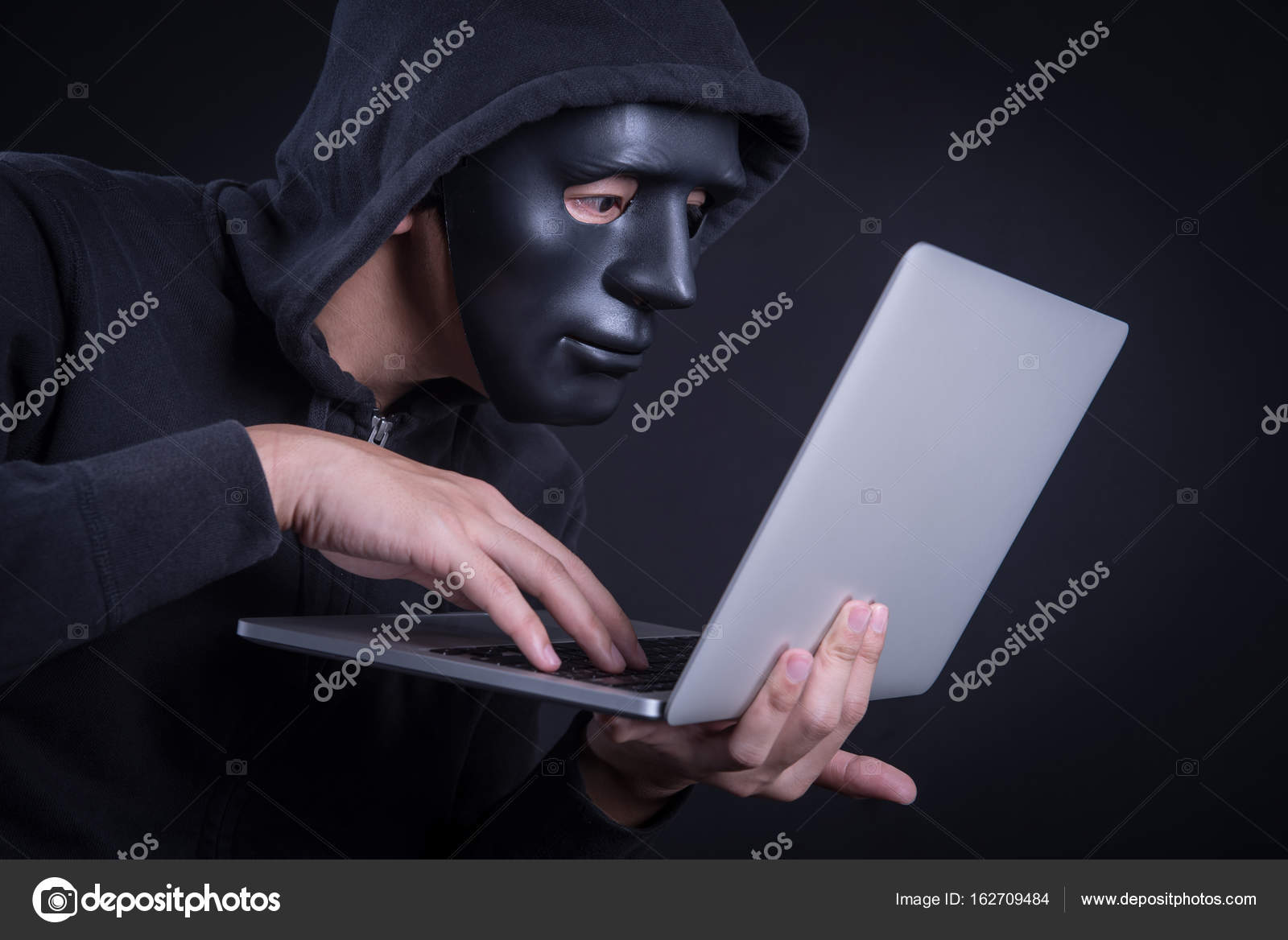 Male hacker with black mask carrying laptop — Stock Photo © zephyr18 ...