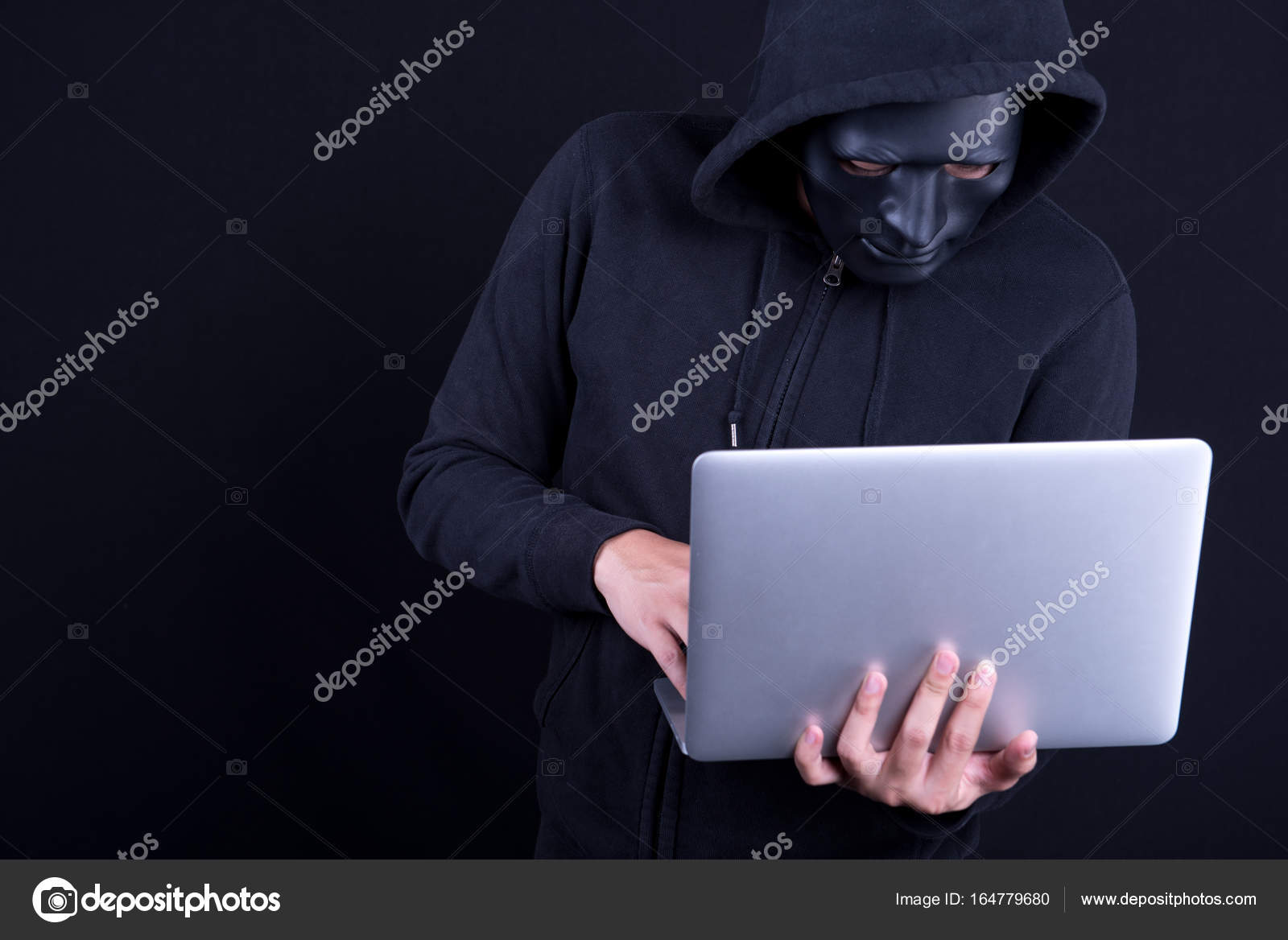 Male hacker with black mask carrying laptop Stock Photo by ©zephyr18 ...