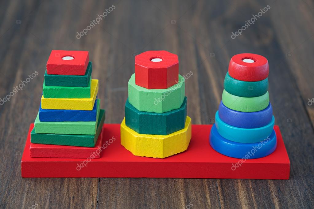 Stack of many shape cube building blocks on wooden table , child ...