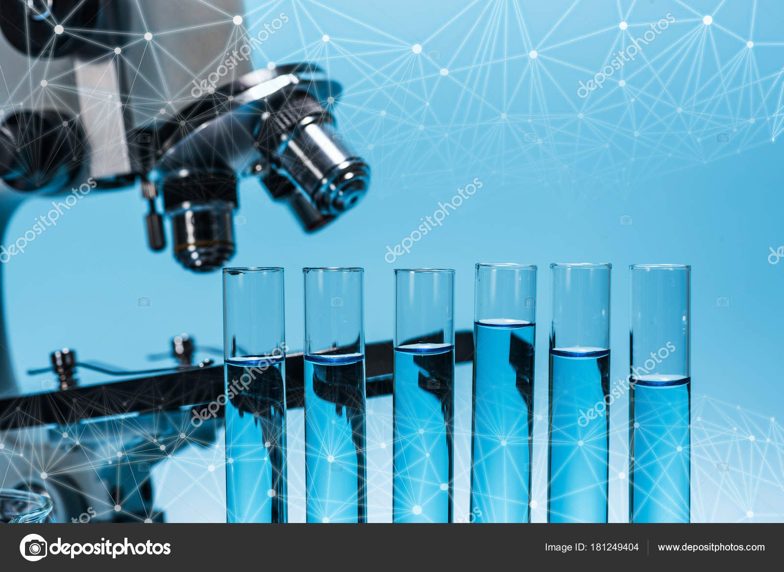Microscope and laboratory test tube on light blue background , s ...
