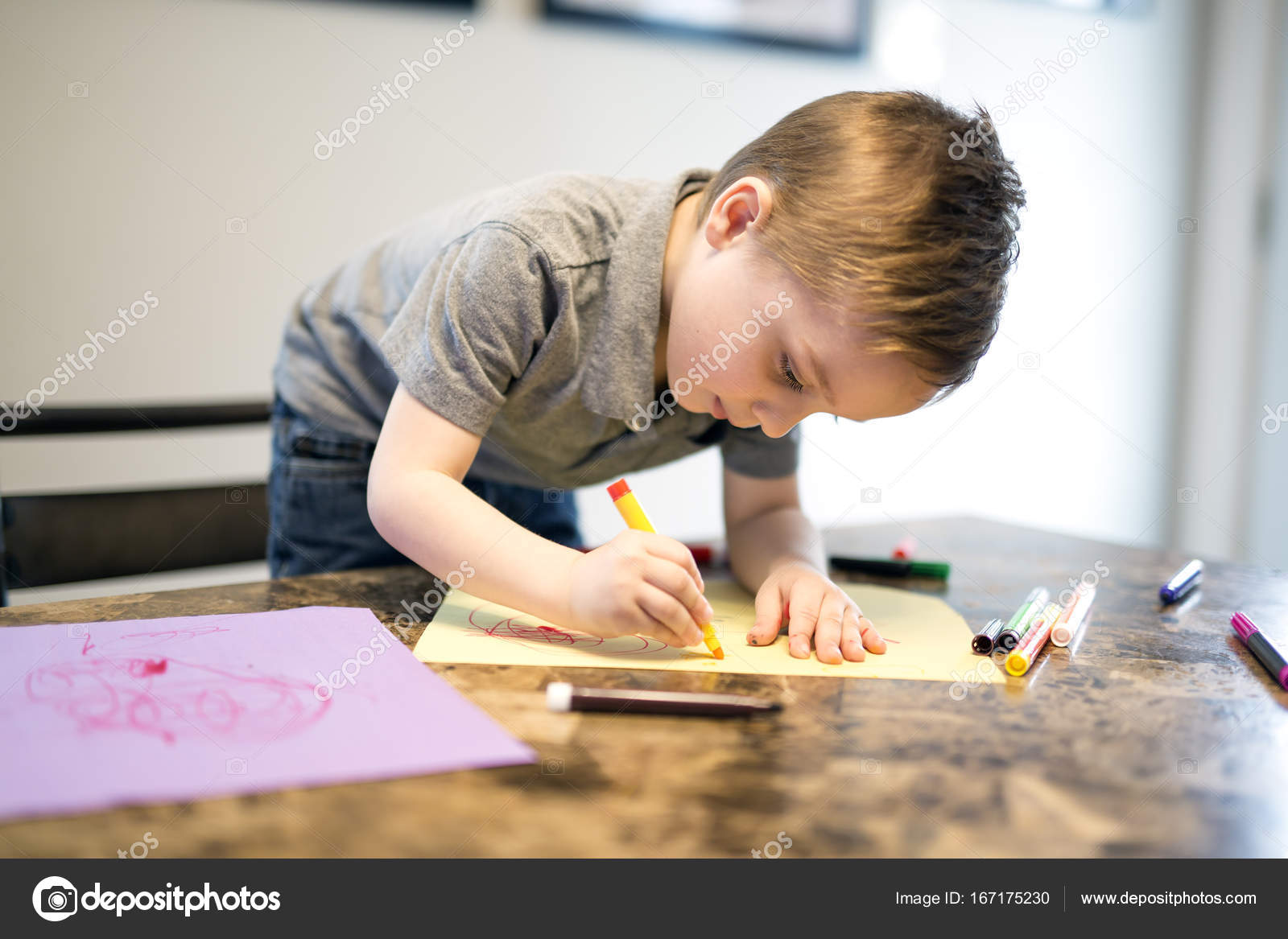 Young Boy Drawing on the kitchen table — Stock Photo © Lopolo #167175230
