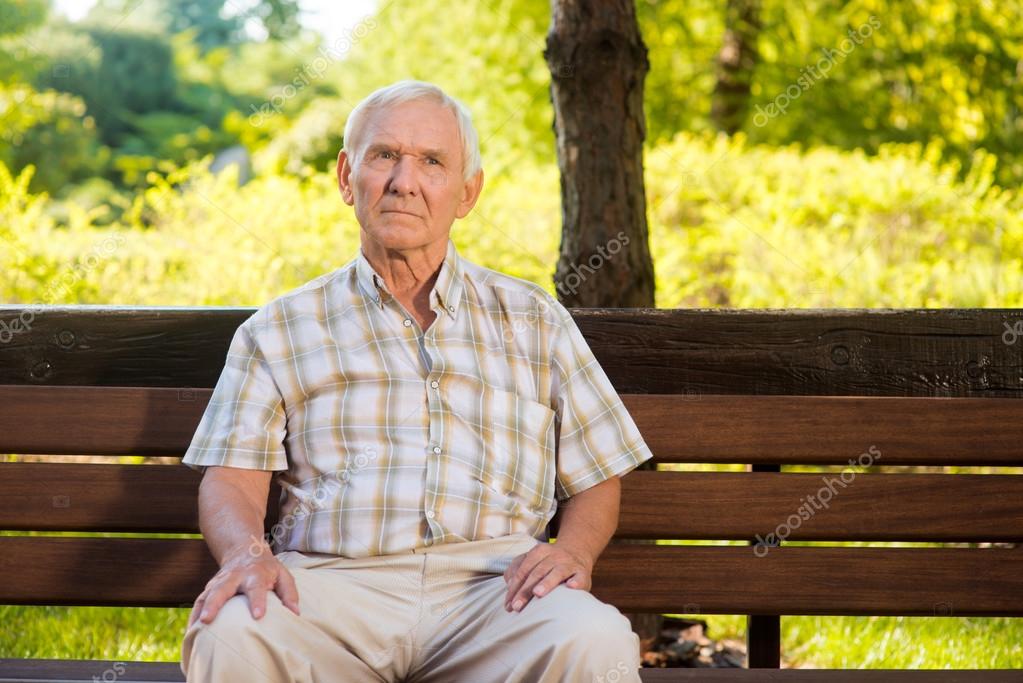 Old man sitting on bench. Stock Photo by ©Denisfilm 127738240