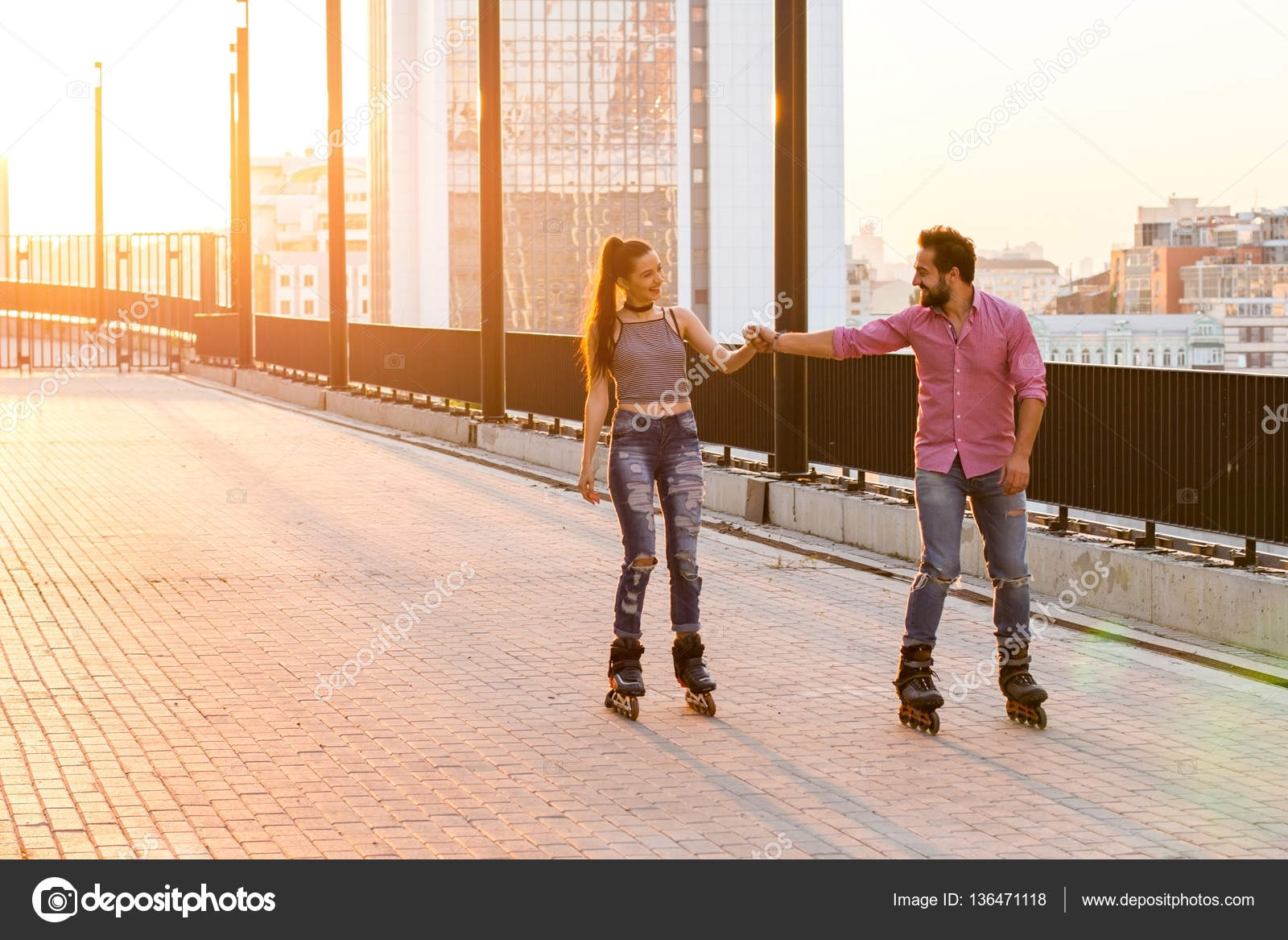 People holding hands and rollerblading. Stock Photo by ©Denisfilm 136471118