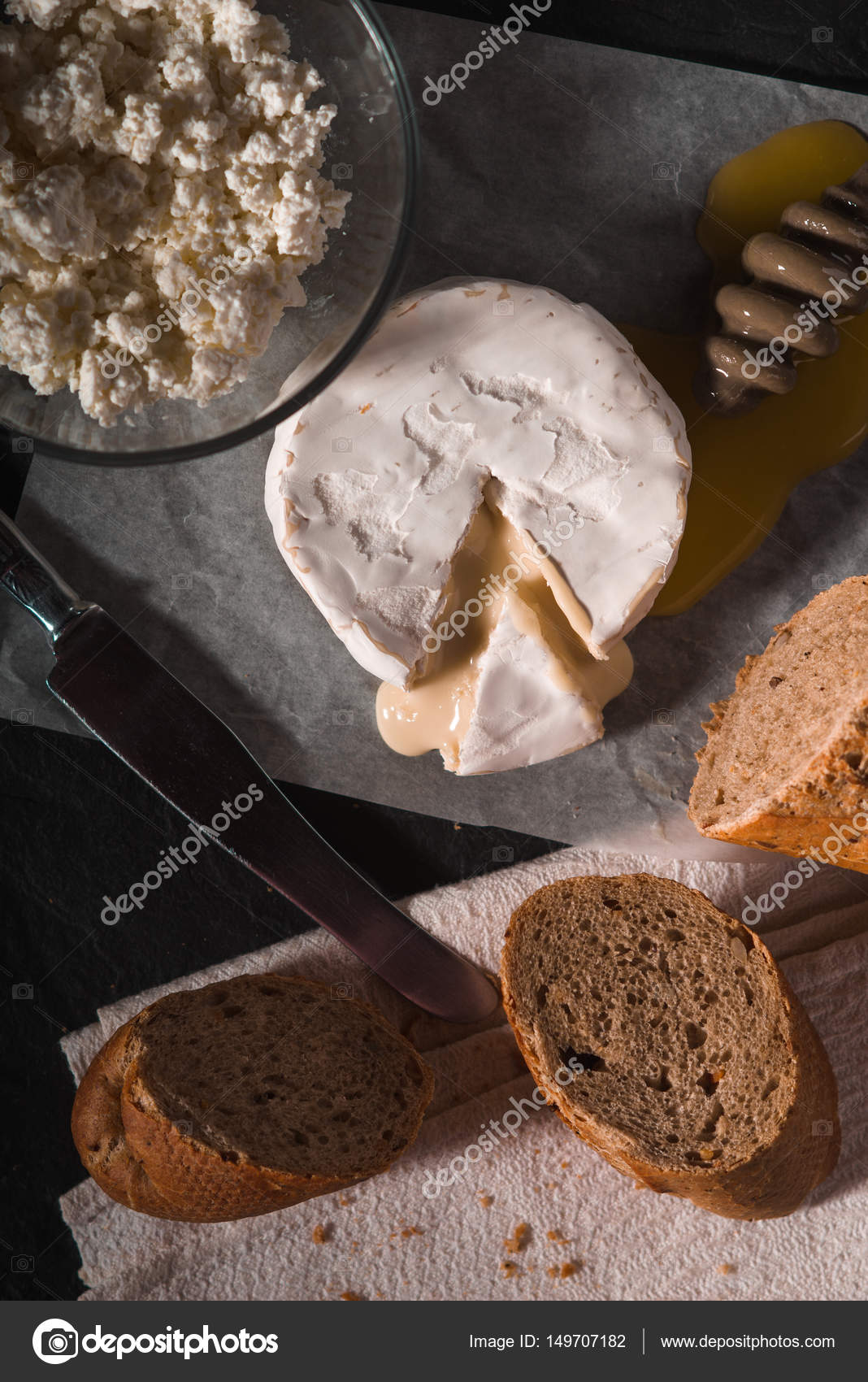 Brie cheese with honey and bread on the stone background vertical ...