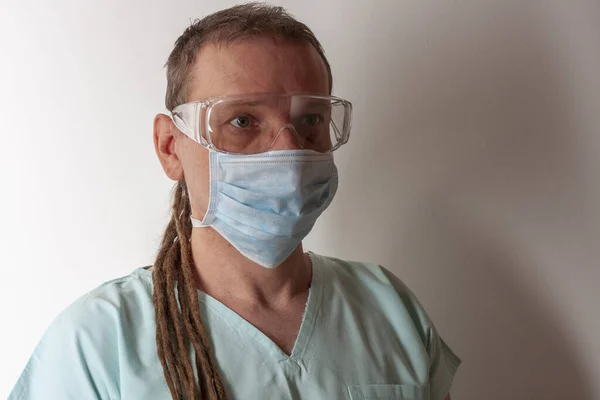 Male nurse, with plastic protective eyeglasses and face mask , with ...