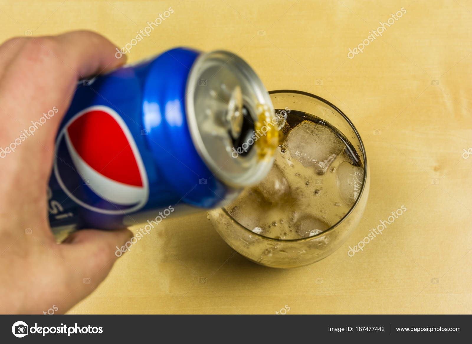 Pouring Pepsi from a can into a glass with ice cubes. – Stock Editorial ...