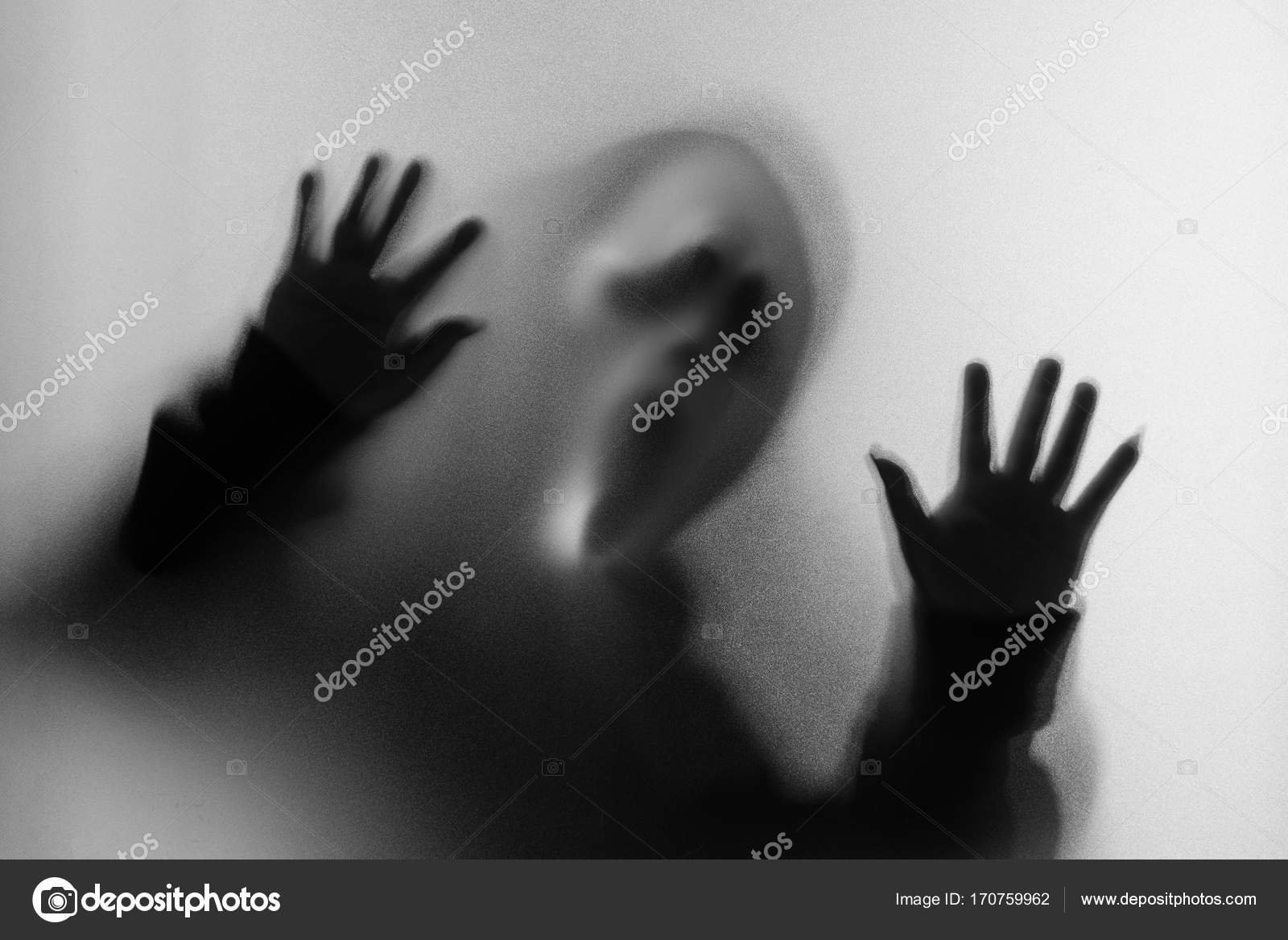Shadow blur of horror man in screaming mask and hand touches the ...