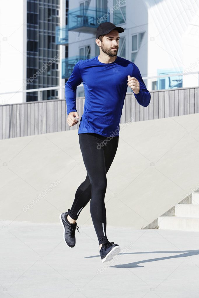 Athletic handsome man running — Stock Photo © sanneberg #125706752