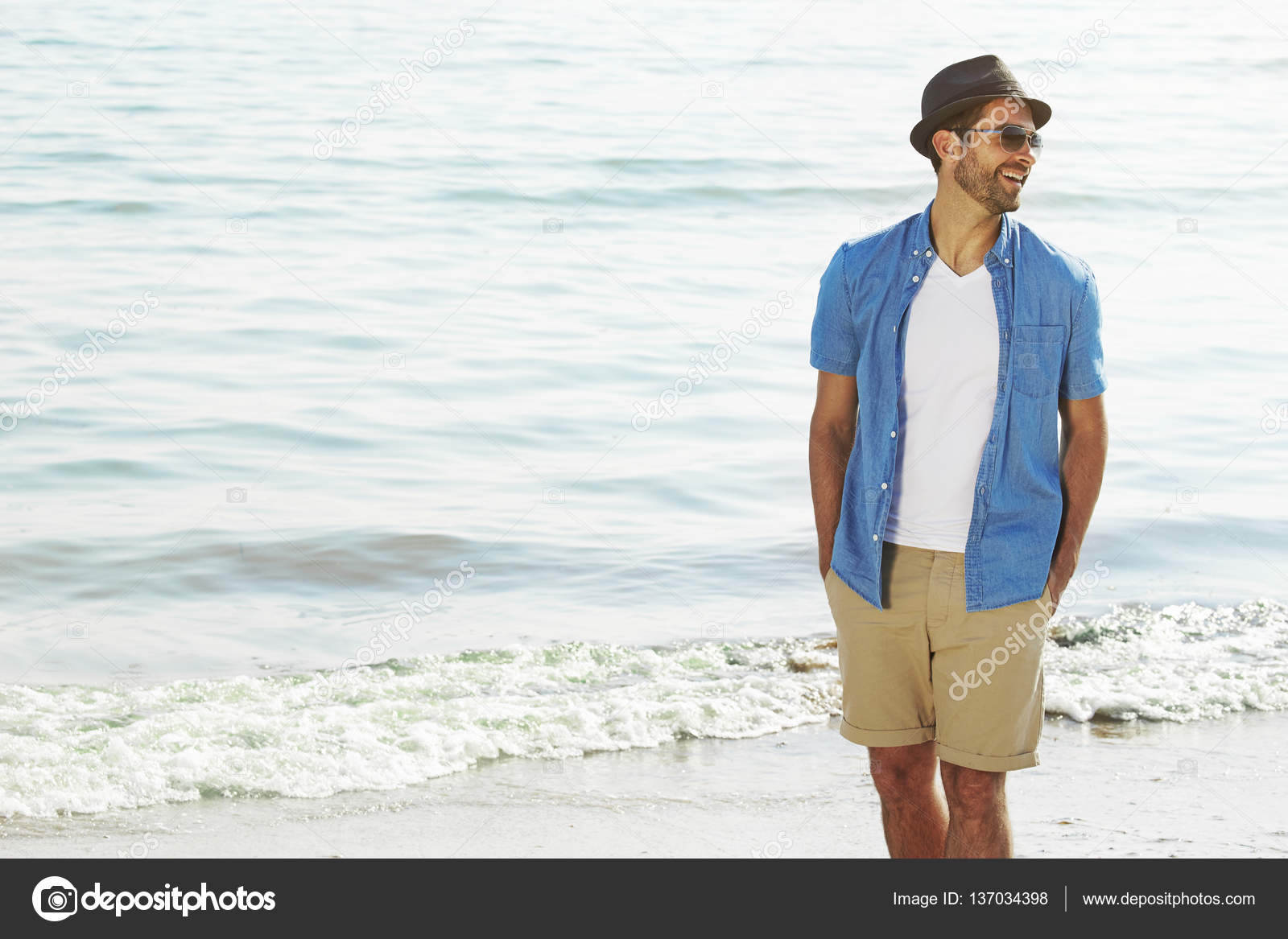 Handsome man on beach — Stock Photo © sanneberg #137034398