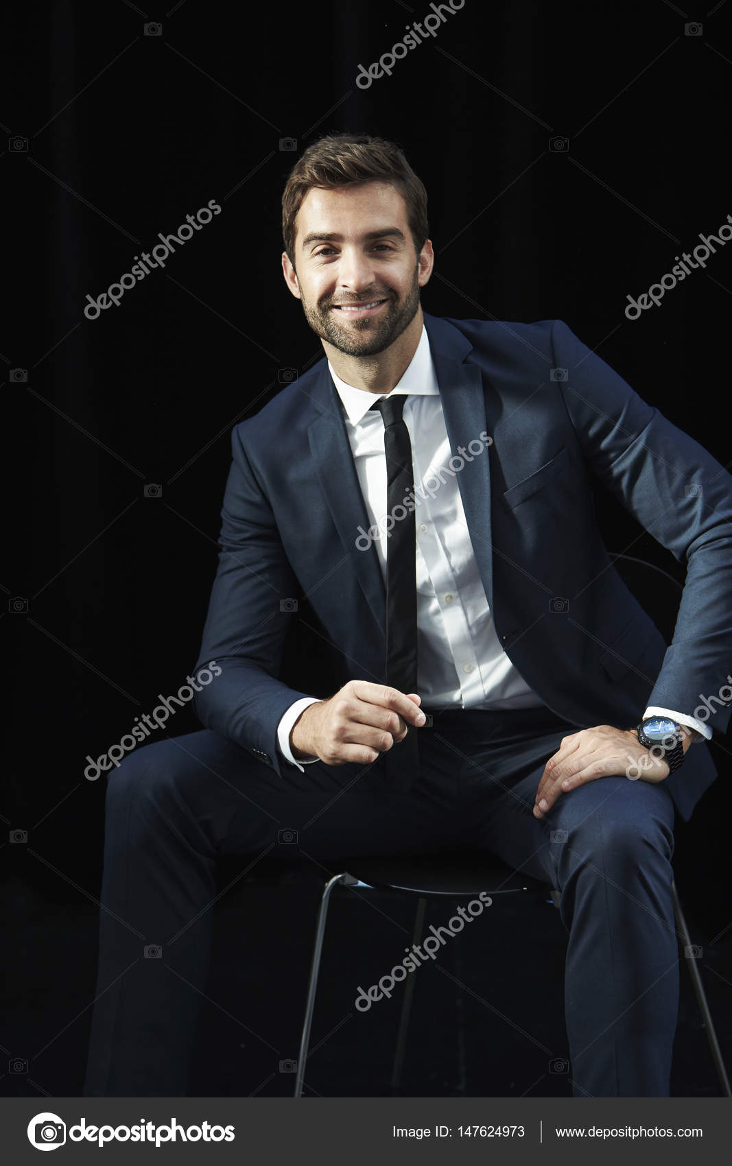 Confident businessman sitting on chair — Stock Photo © sanneberg #147624973 Confident businessman sitting on chair — Stock Photo © sanneberg #147624973
