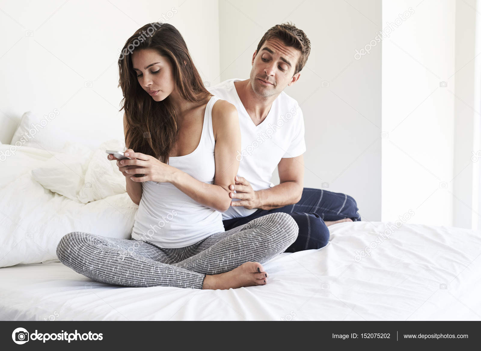 Dude peering over girlfriend shoulder Stock Photo by ©sanneberg 152075202