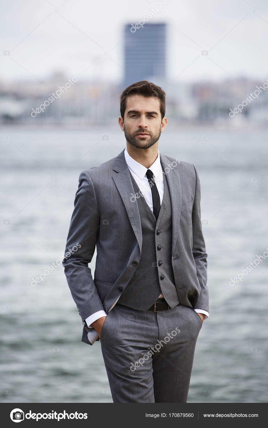 Serious businessman in grey suit Stock Photo by ©sanneberg 170879560