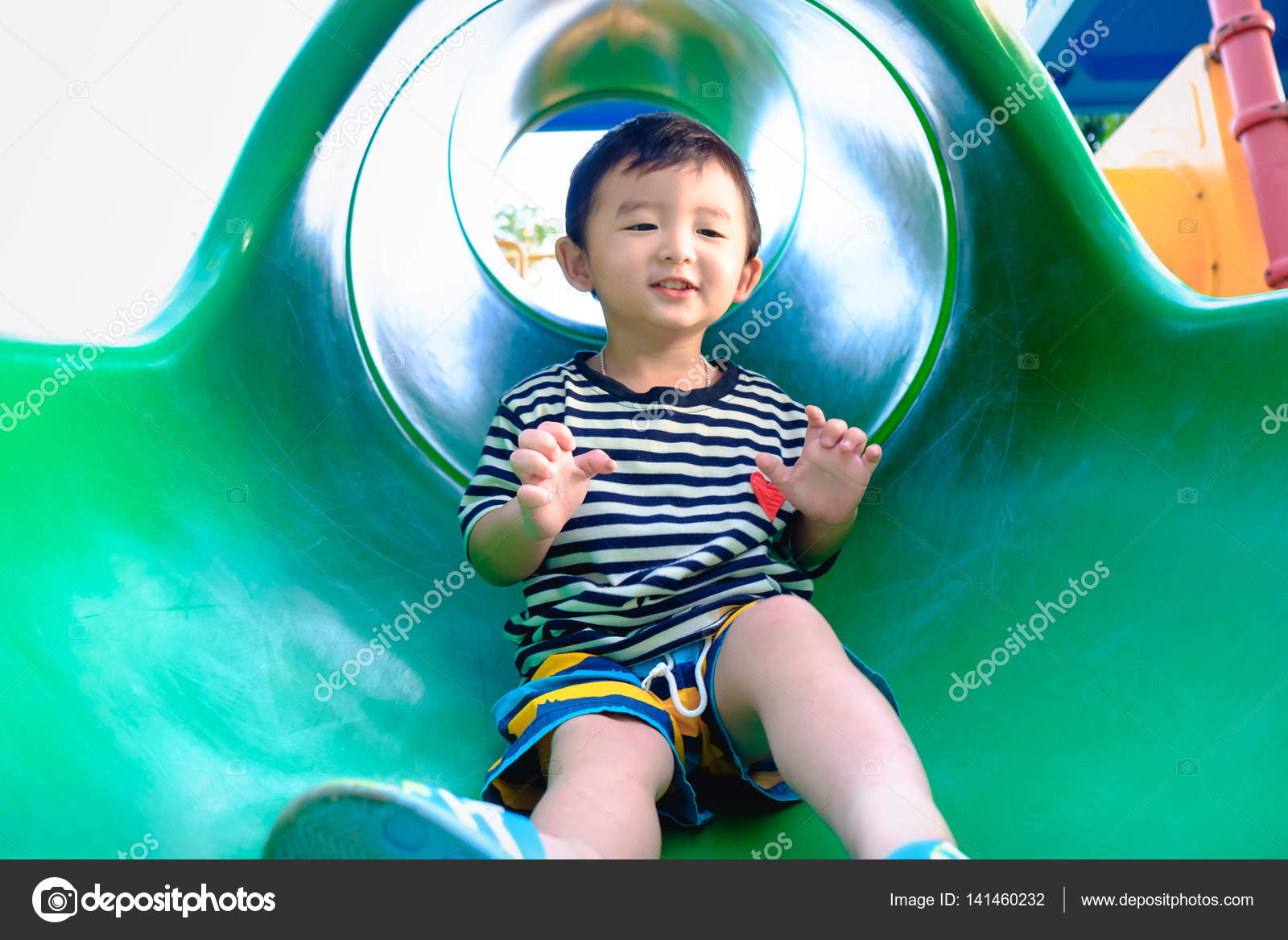 Little Asian kid playing slide at the playground — Stock Photo ...