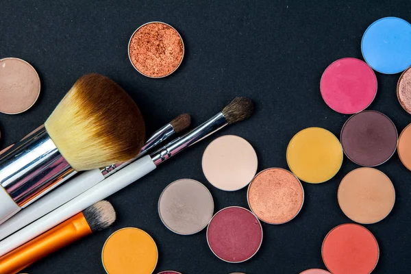 Make-up colorful eyeshadow palettes isolated on black background. View ...